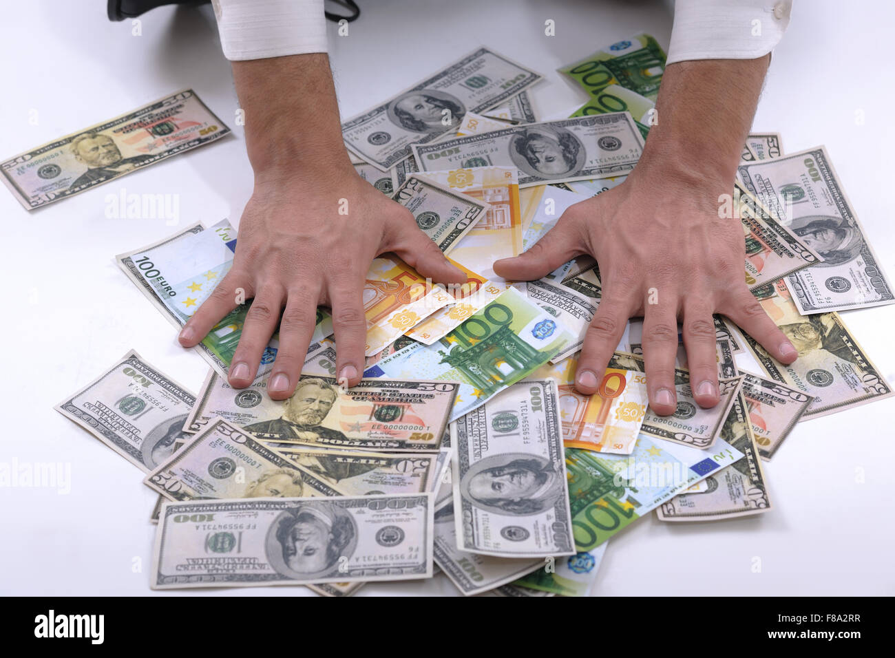 Portrait of a business man holding and catch falling money bills ...