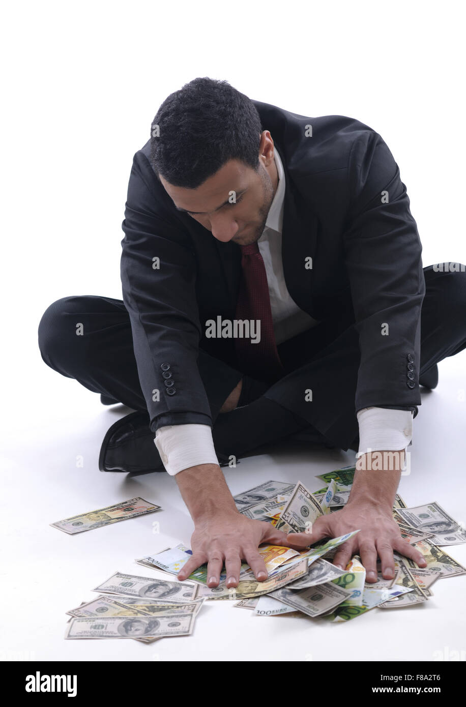Portrait of a business man holding and catch falling money bills ...
