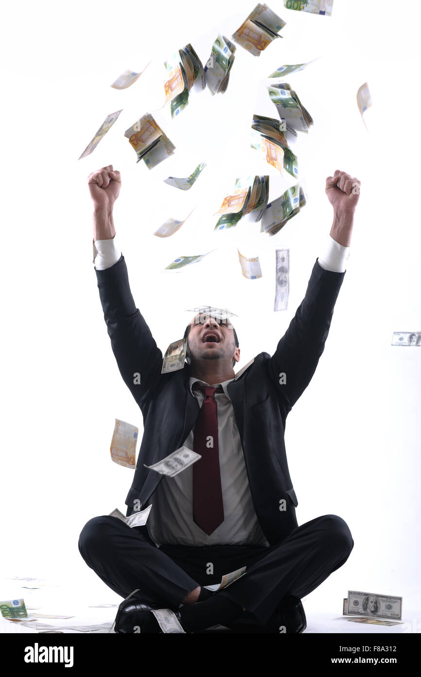 Portrait of a business man holding and catch falling money bills ...