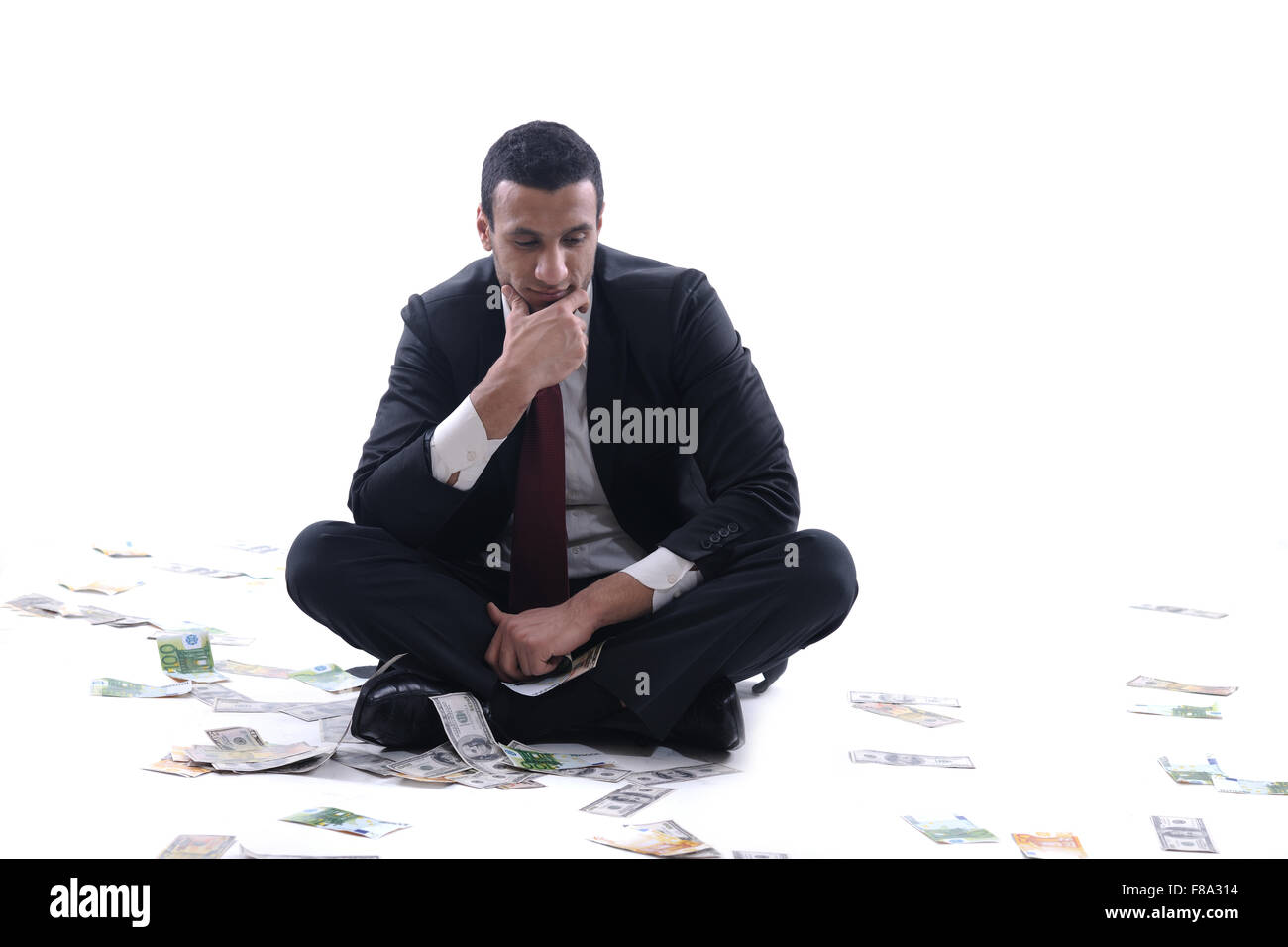 Portrait of a business man holding and catch falling money bills ...