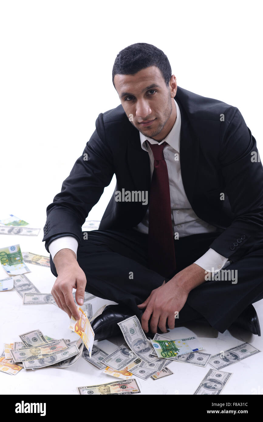 Portrait of a business man holding and catch falling money bills ...