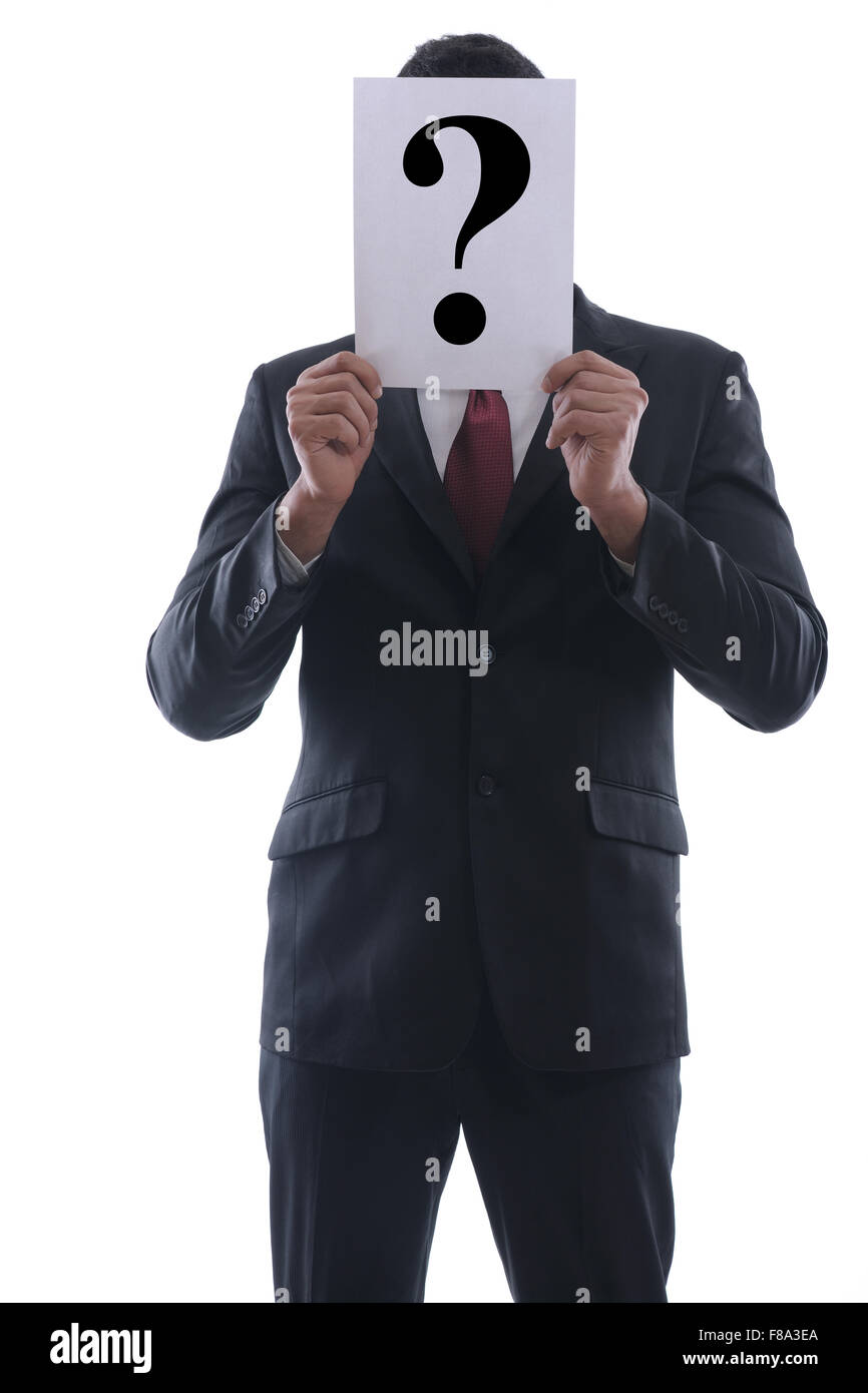 Business man holding a piece of paper over his face with a question ...