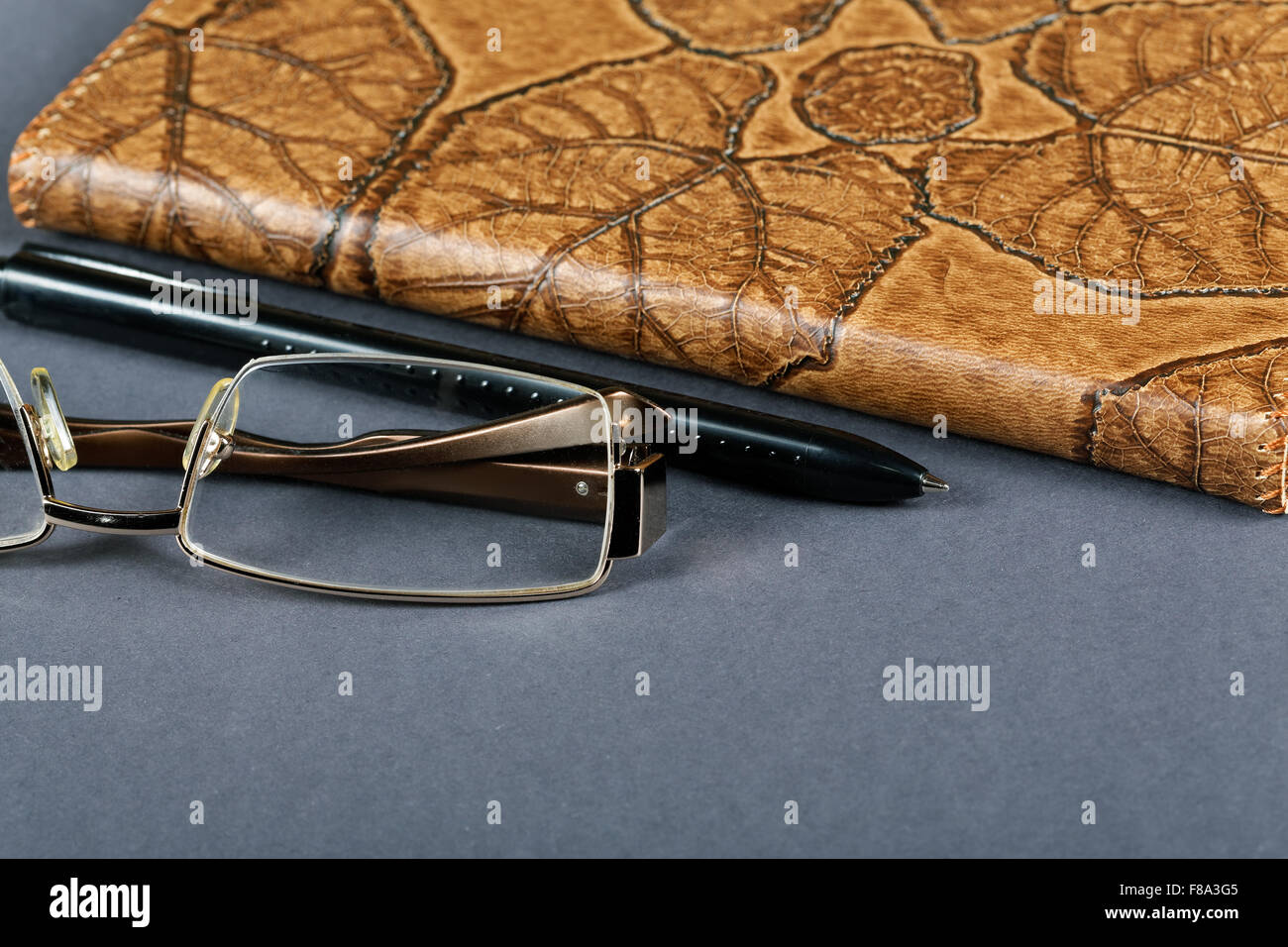 Pencil glasses and a writing-book close up Stock Photo - Alamy