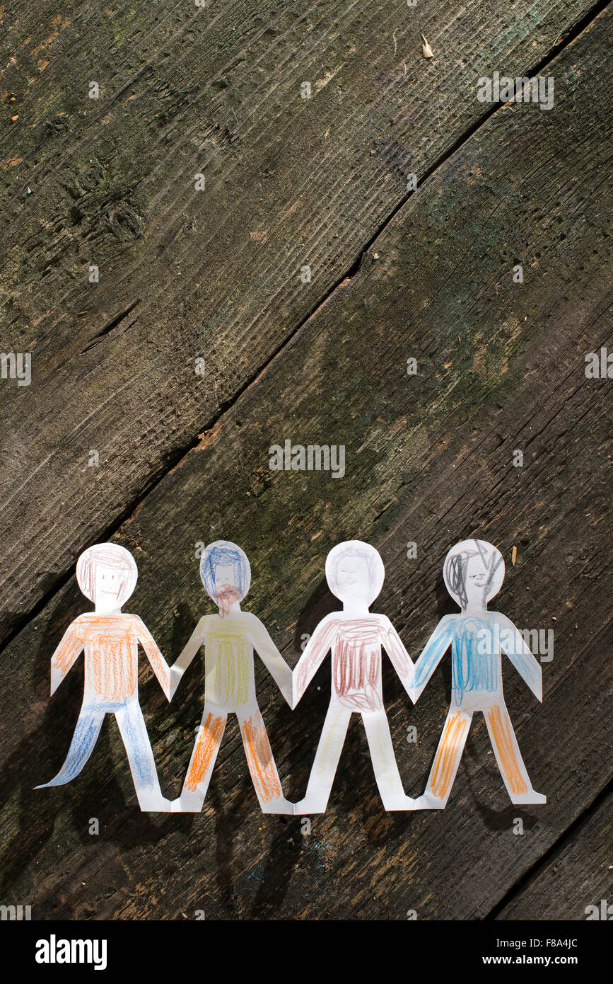Paper made people figures. Painted white figures on wooden board Stock ...