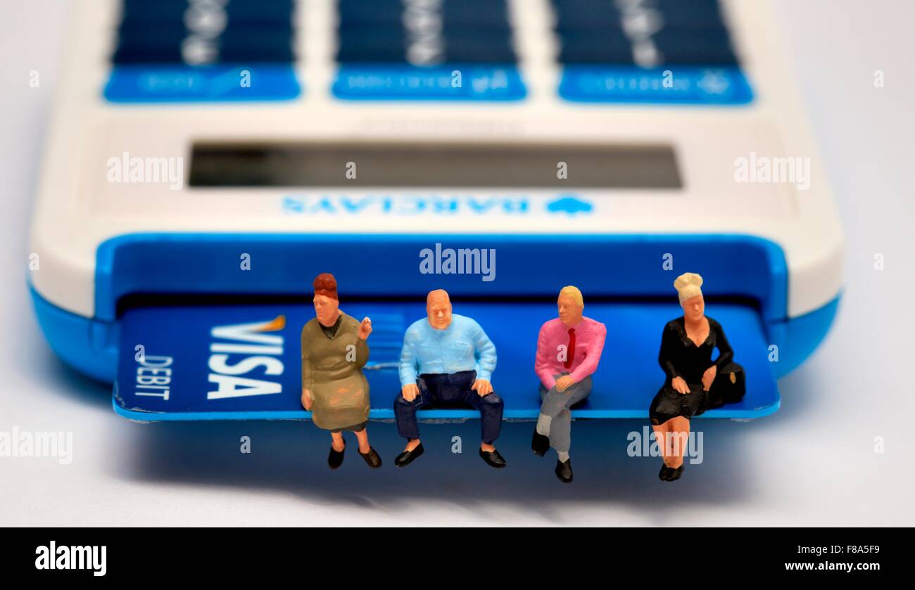 Miniature people sitting on a visa debit card Stock Photo - Alamy