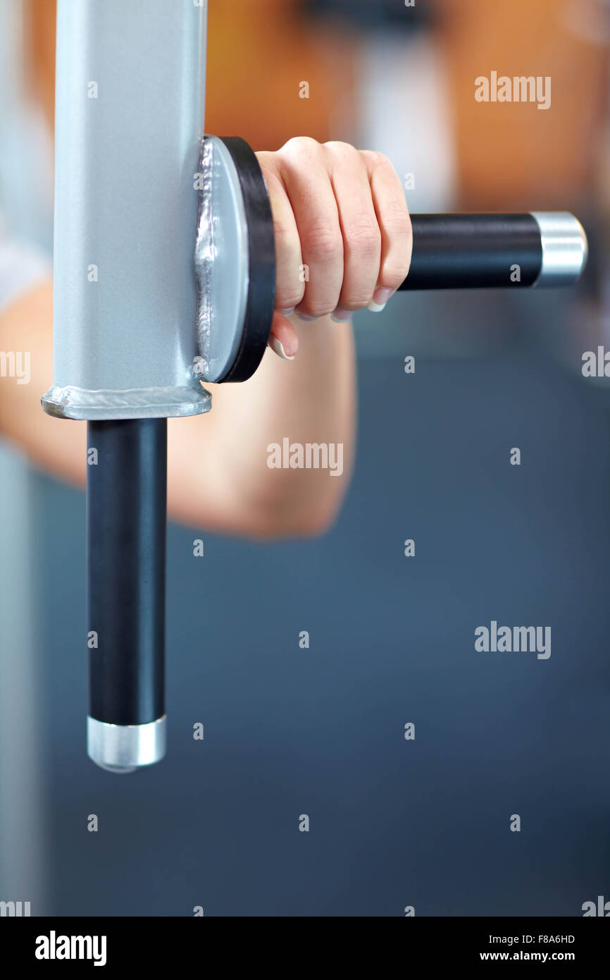 Female hand holding handle on training machine in gym Stock Photo - Alamy
