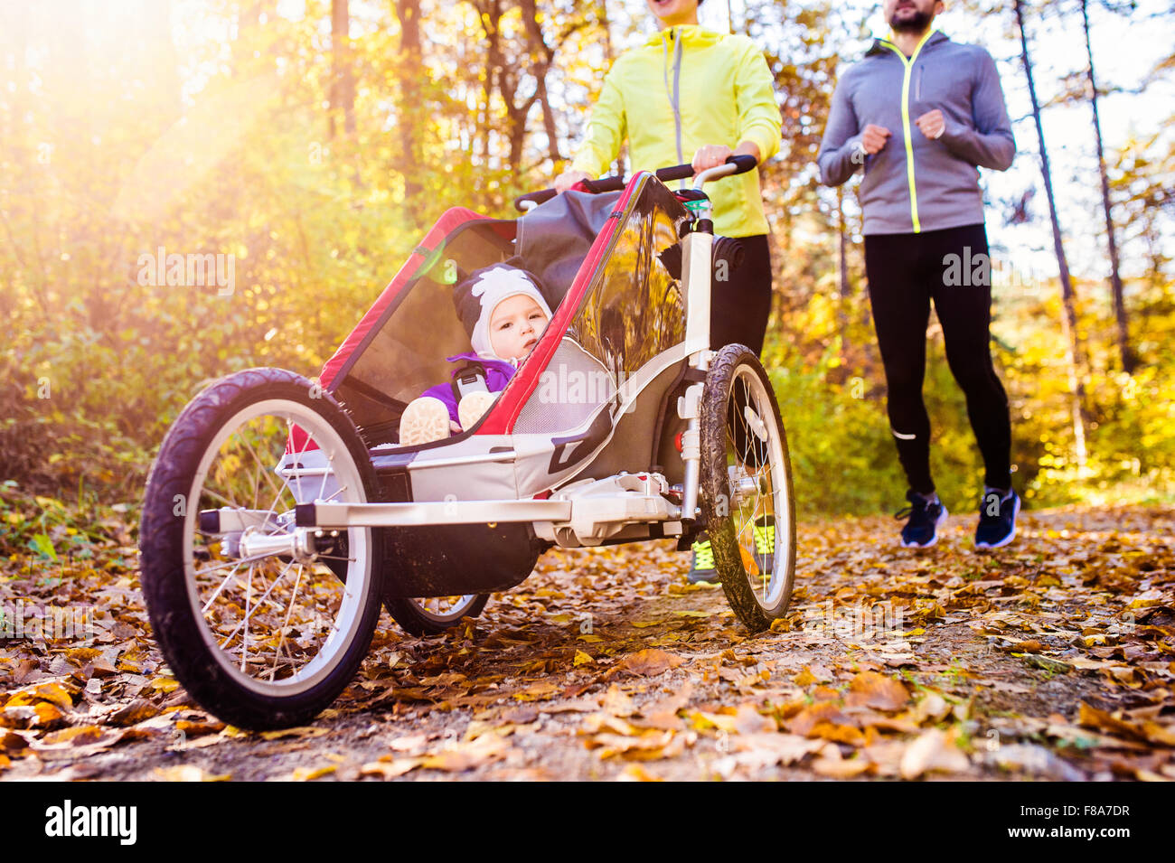 Young family running Stock Photo - Alamy