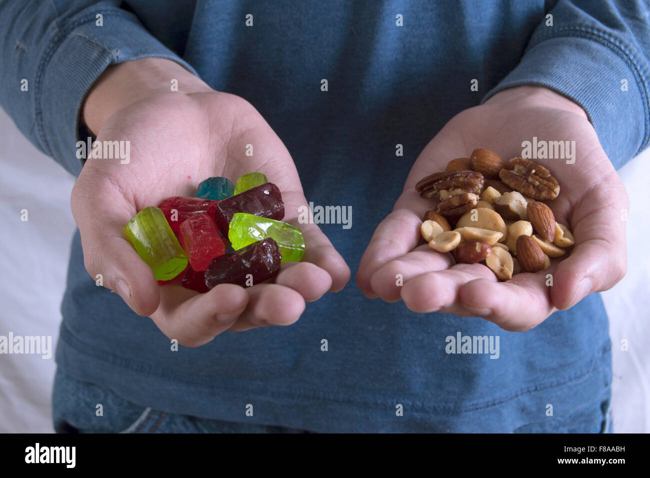 healthy and junk food in hands Stock Photo - Alamy