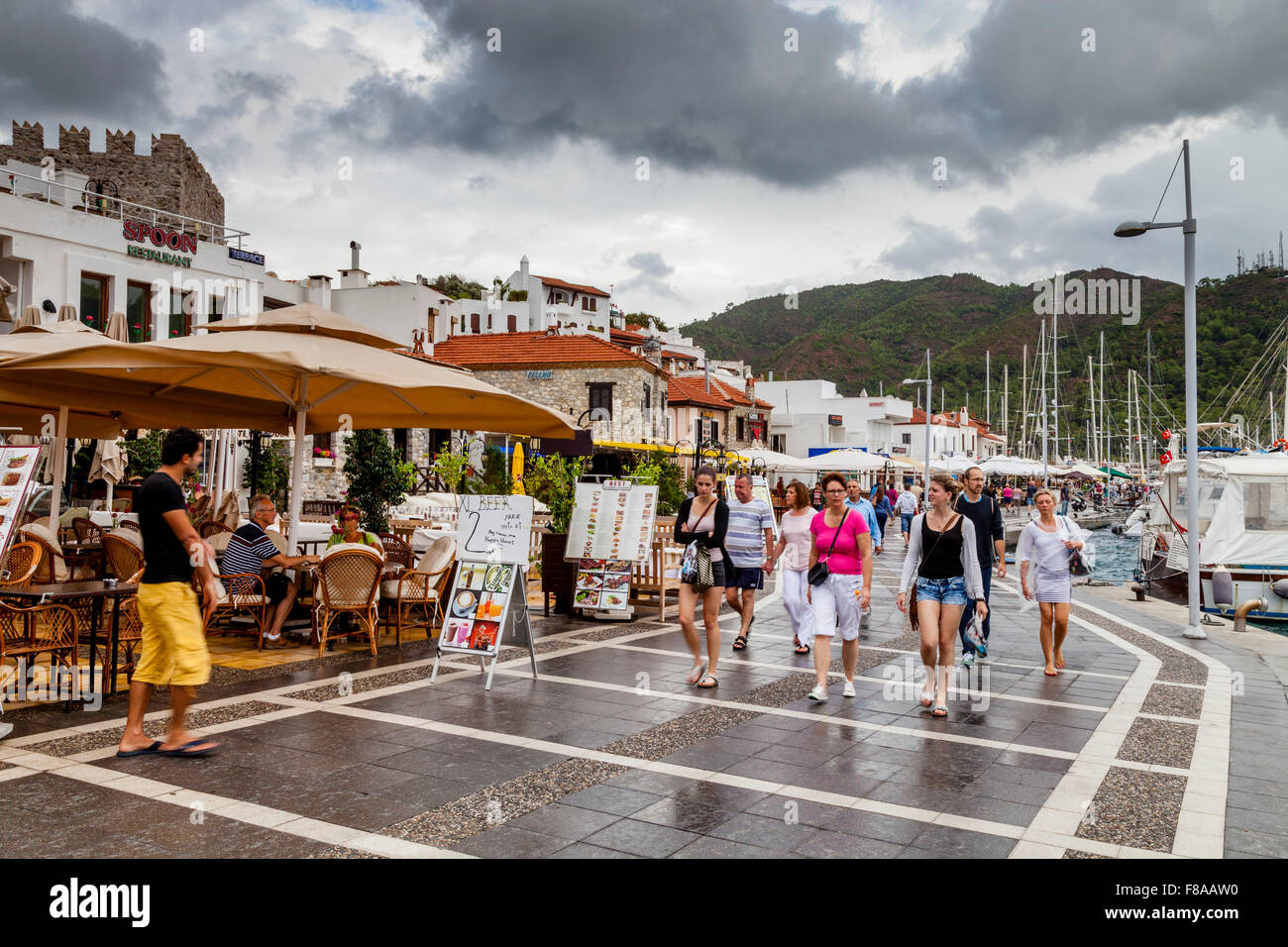 Tourists Walk Along The Seafront In The Rain, Marmaris, Mugla Province ...