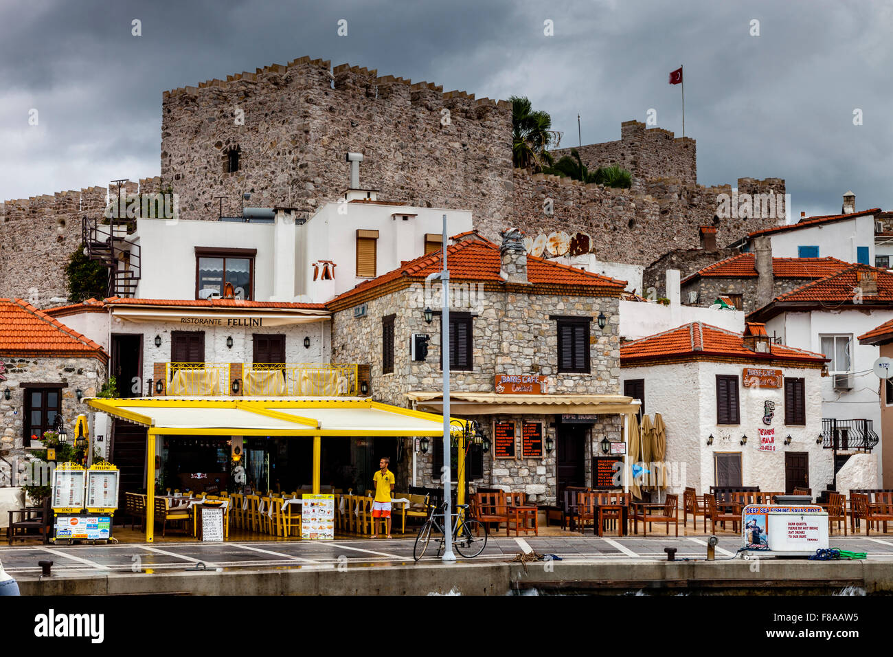 A Restaurant Worker Waits In The Rain For Passing Tourists, Marmaris ...