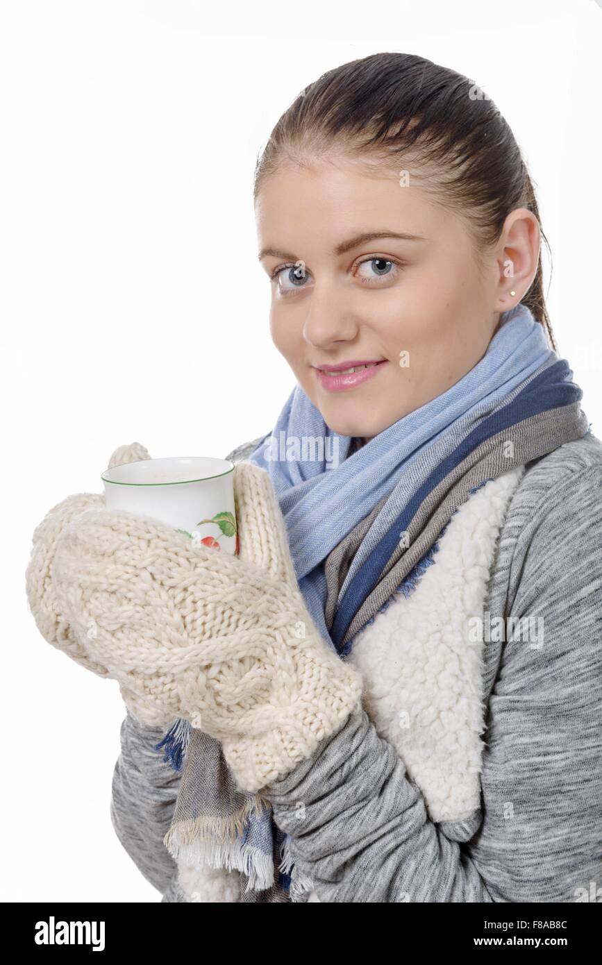a young woman drinking tea with mittens to warm Stock Photo - Alamy