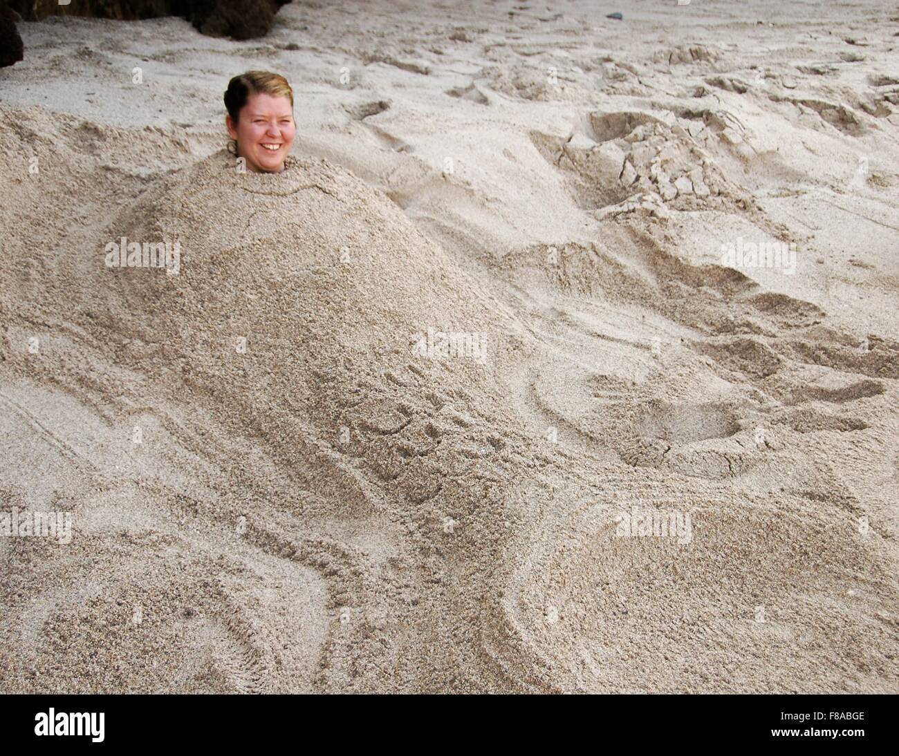 Girl Buried In Sand High Resolution Stock Photography and Images - Alamy