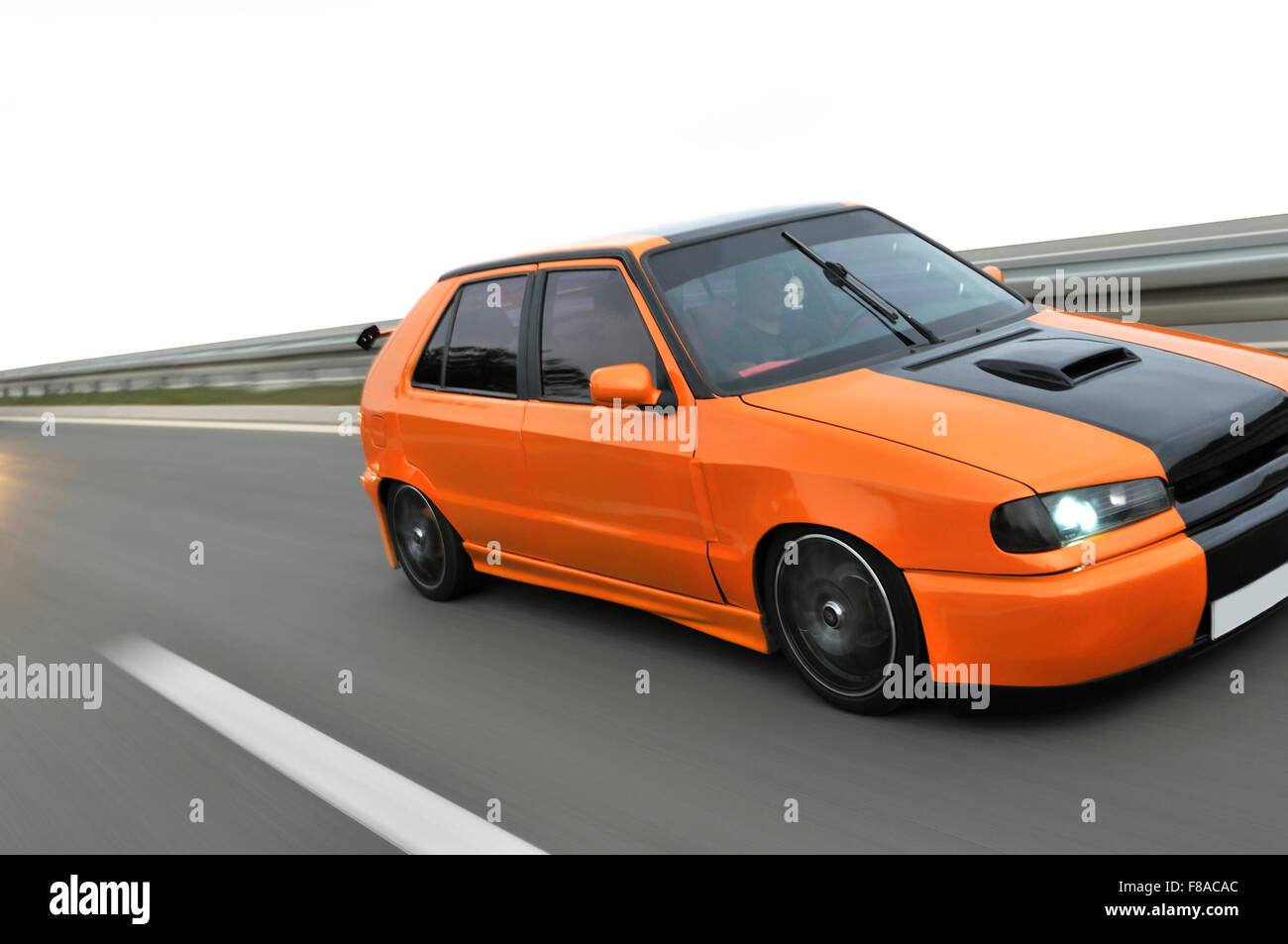 Picture of fast isolated tuning car speeding on highway Stock Photo - Alamy