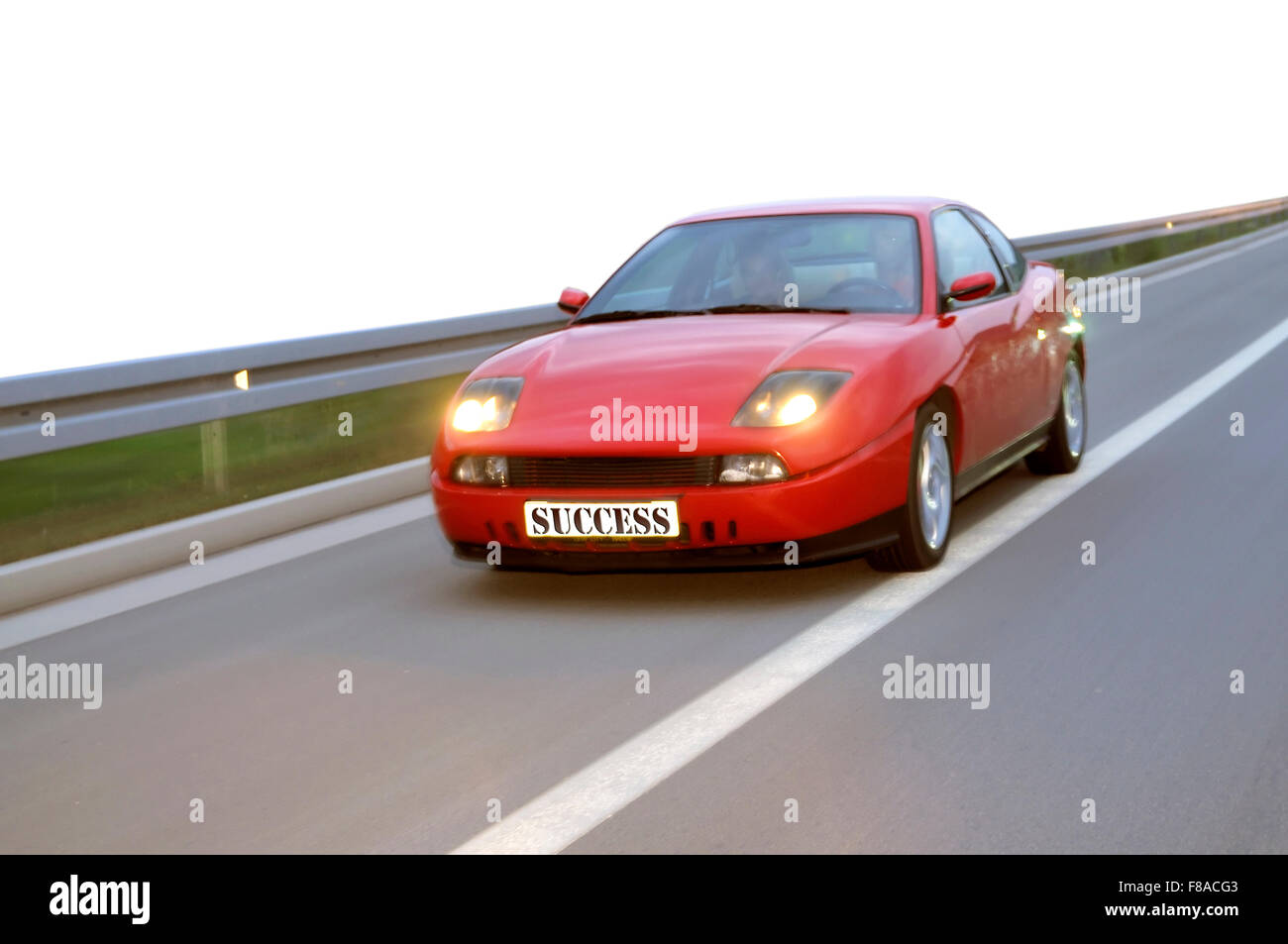 Red car riding down the highway Stock Photo - Alamy