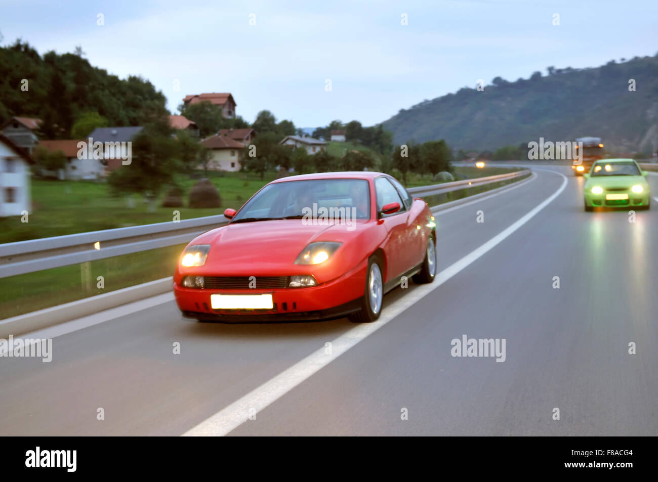 Picutre of tuning cars speeding on highway captured with long exposure ...