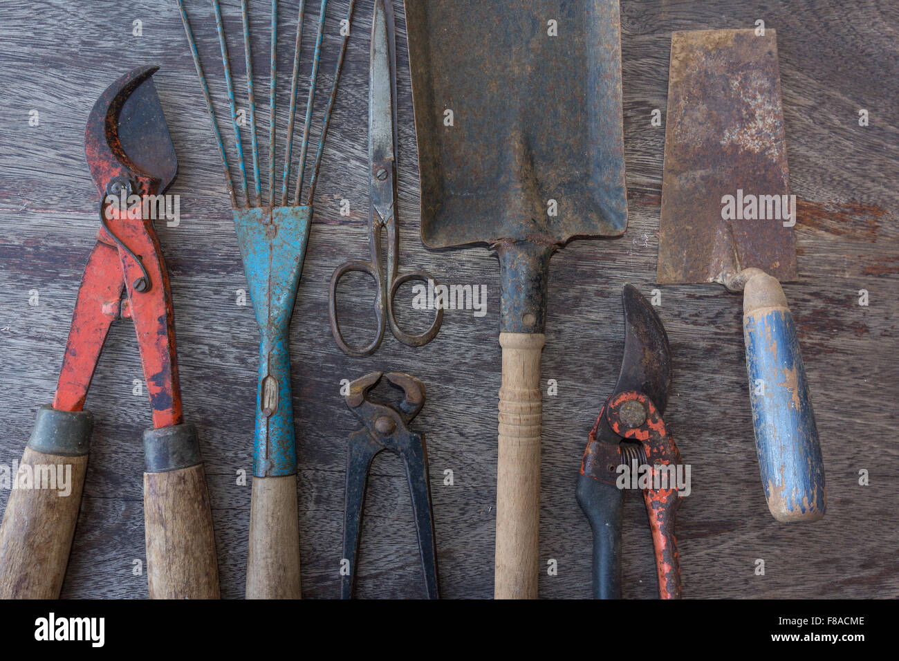 Old rusty tools - vintage handicraft tools on wooden background Stock ...