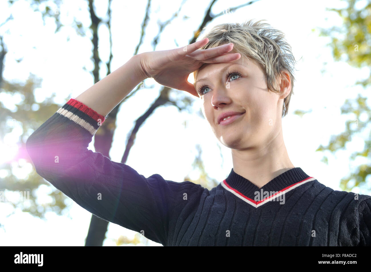 Young woman taking a look at the world around Stock Photo - Alamy