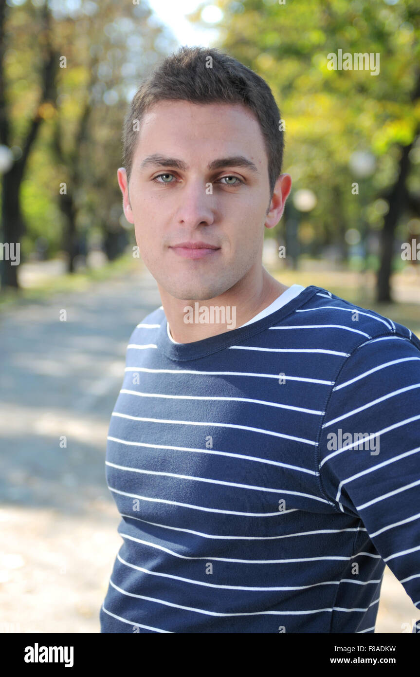 Handsome young man looking in nature Stock Photo - Alamy