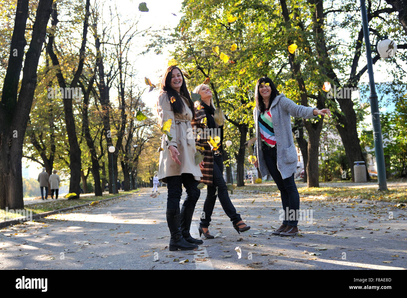 Happy three friends having fun outdoors in nature Stock Photo - Alamy