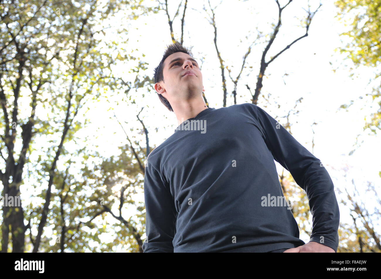 Handsome young man looking in nature Stock Photo - Alamy