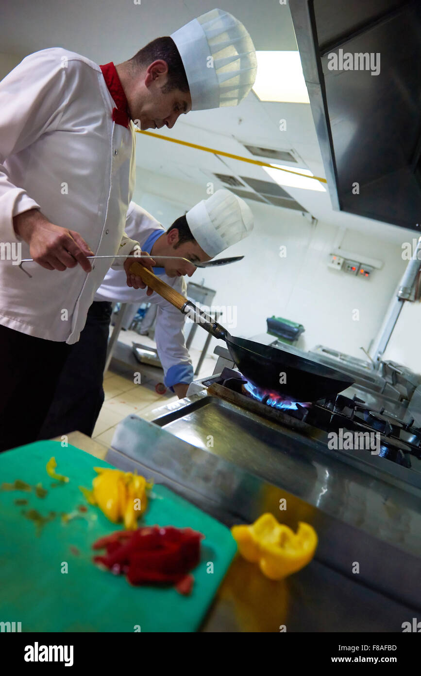 chef in hotel kitchen prepare vegetable food with fire Stock Photo - Alamy
