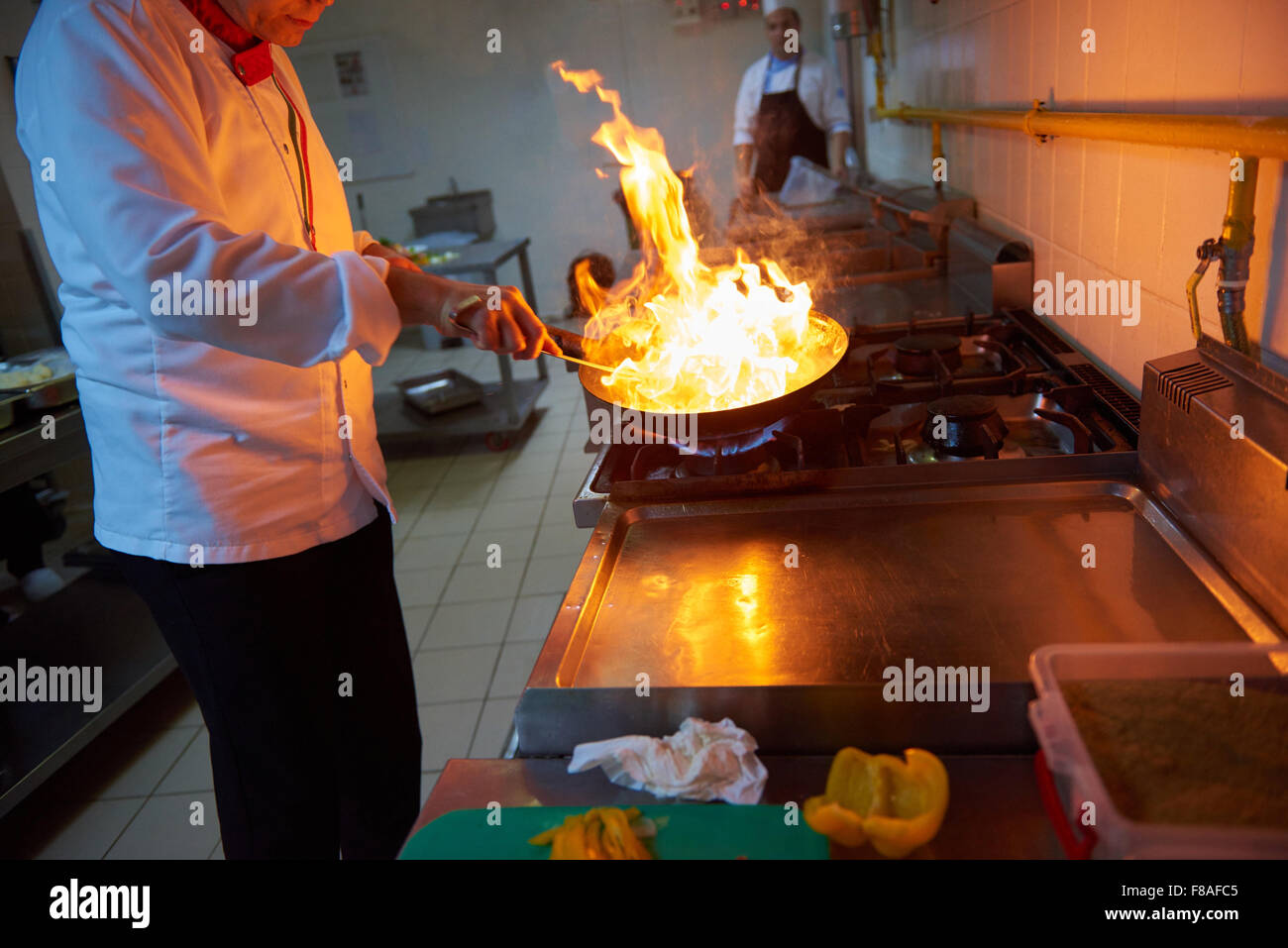 chef in hotel kitchen prepare vegetable food with fire Stock Photo - Alamy