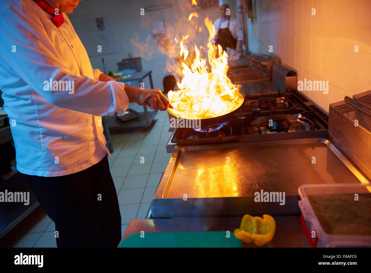 chef in hotel kitchen prepare vegetable food with fire Stock Photo - Alamy