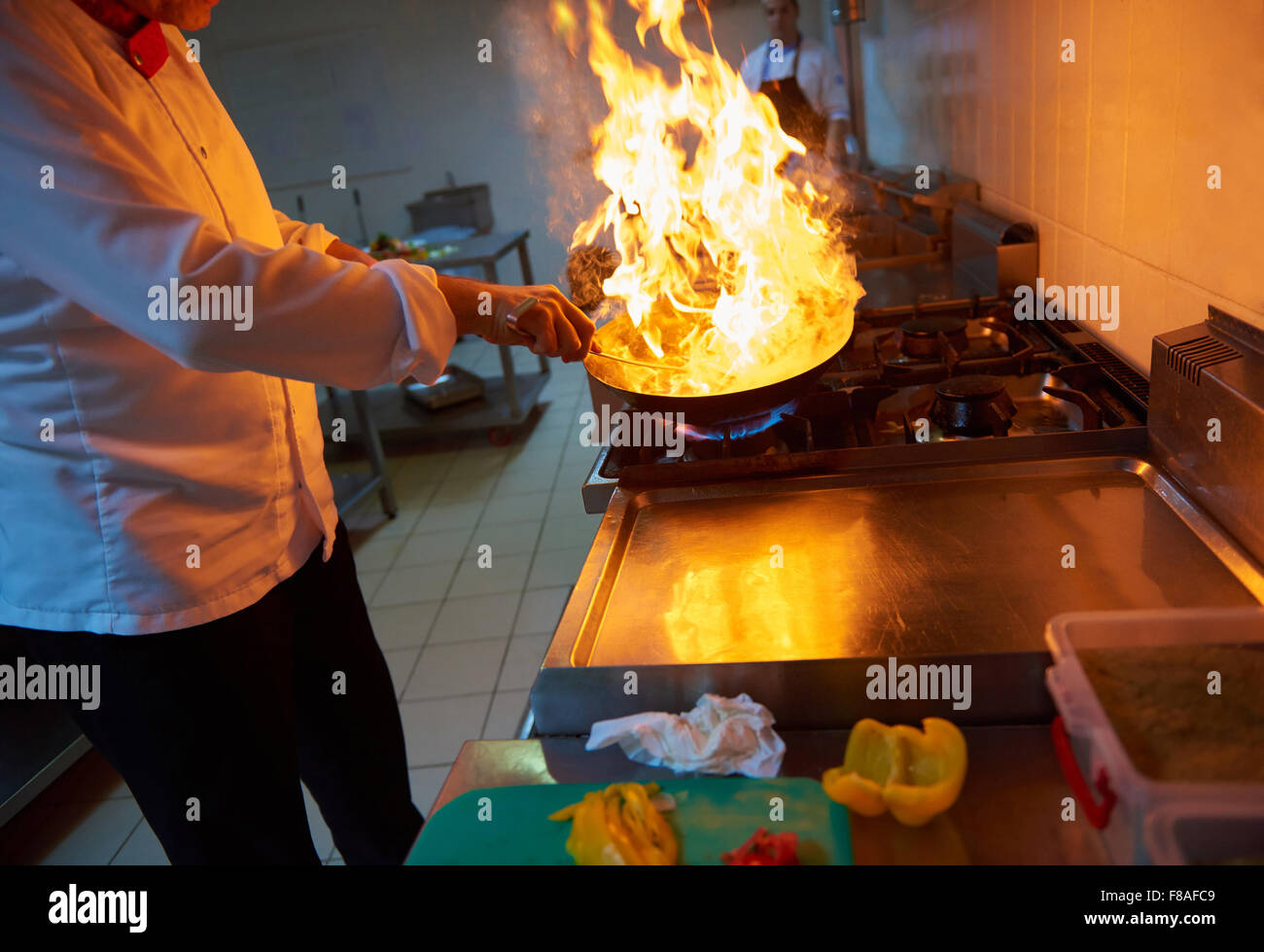 chef in hotel kitchen prepare vegetable food with fire Stock Photo - Alamy