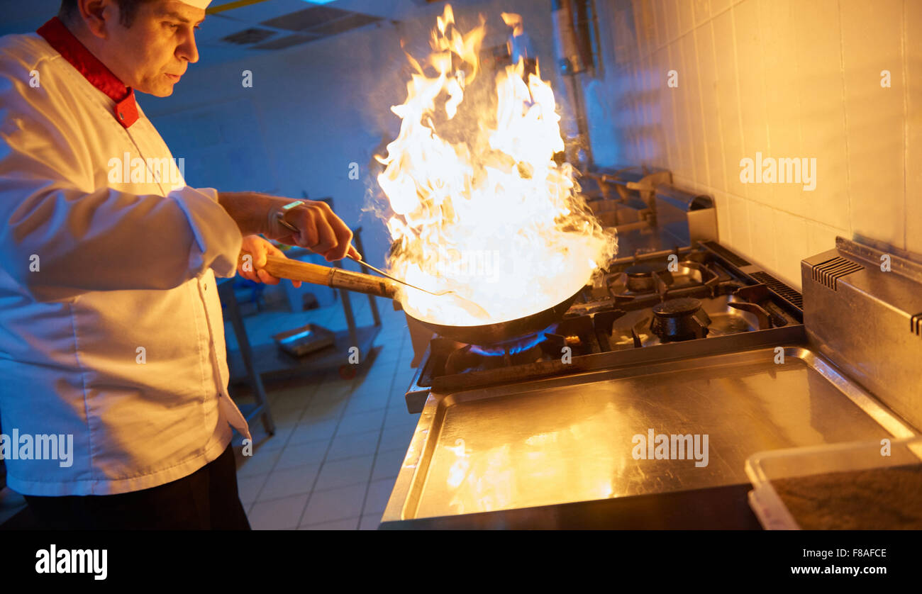 chef in hotel kitchen prepare vegetable food with fire Stock Photo - Alamy