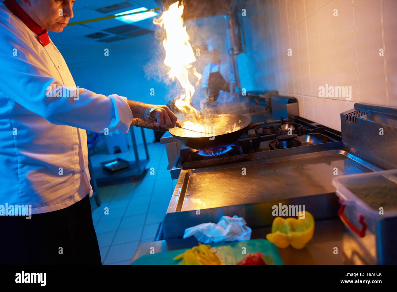 chef in hotel kitchen prepare vegetable food with fire Stock Photo - Alamy