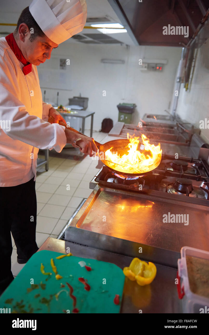 chef in hotel kitchen prepare vegetable food with fire Stock Photo - Alamy