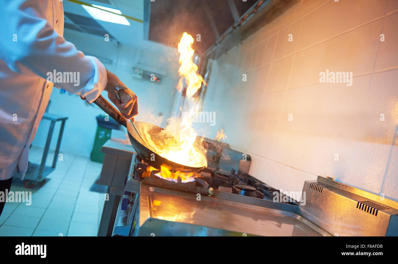 chef in hotel kitchen prepare vegetable food with fire Stock Photo - Alamy