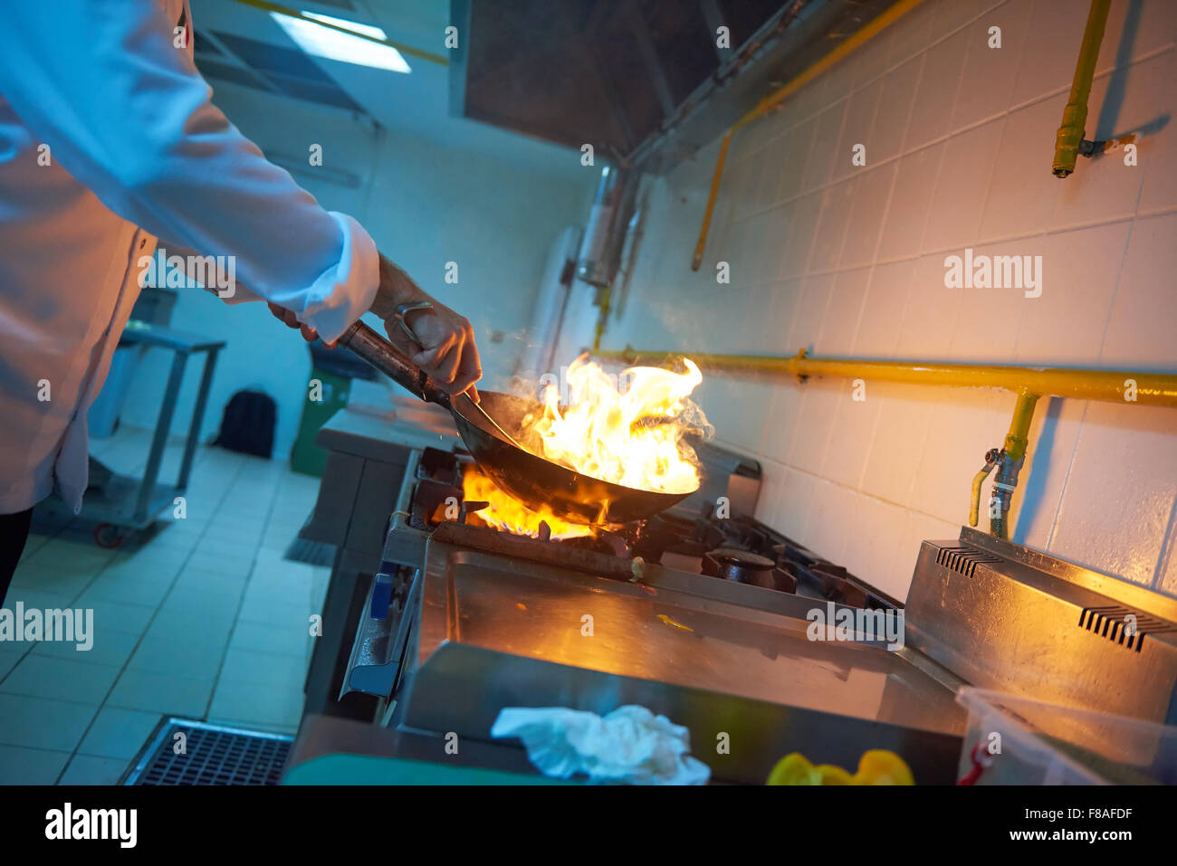 chef in hotel kitchen prepare vegetable food with fire Stock Photo - Alamy