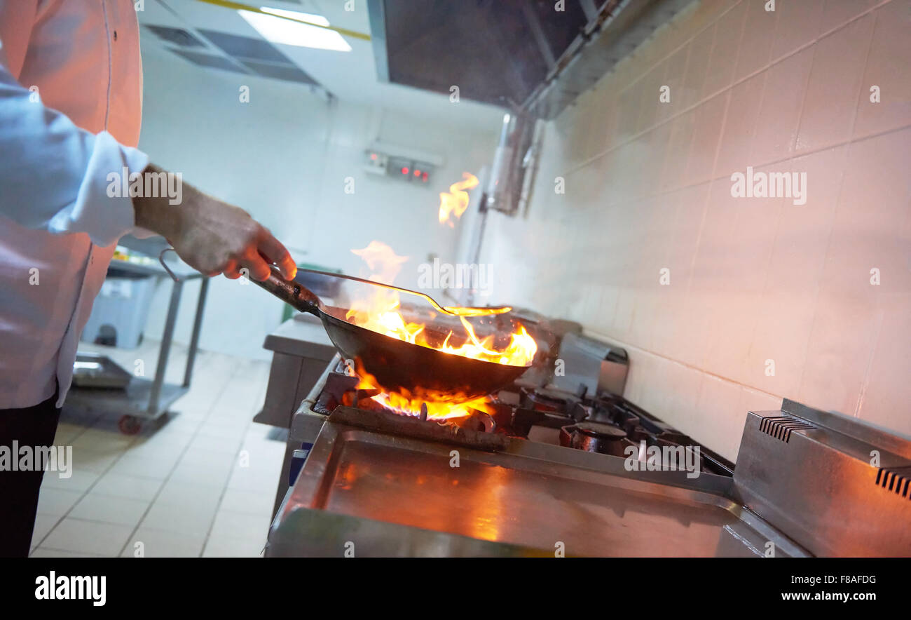 chef in hotel kitchen prepare vegetable food with fire Stock Photo - Alamy