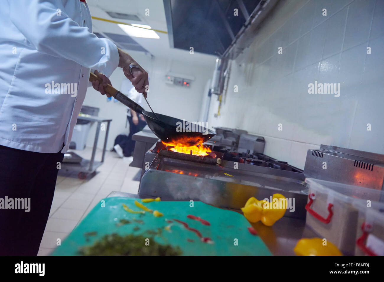 chef in hotel kitchen prepare vegetable food with fire Stock Photo - Alamy