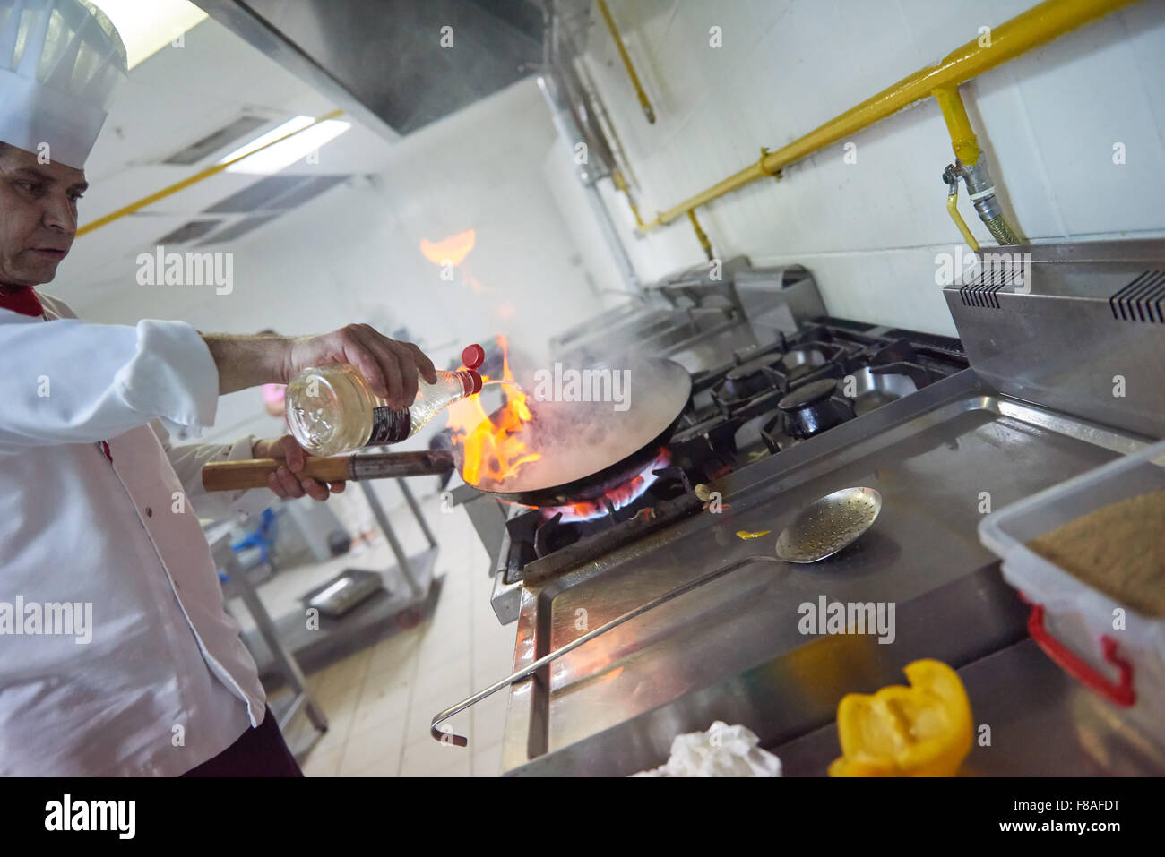 chef in hotel kitchen prepare vegetable food with fire Stock Photo - Alamy