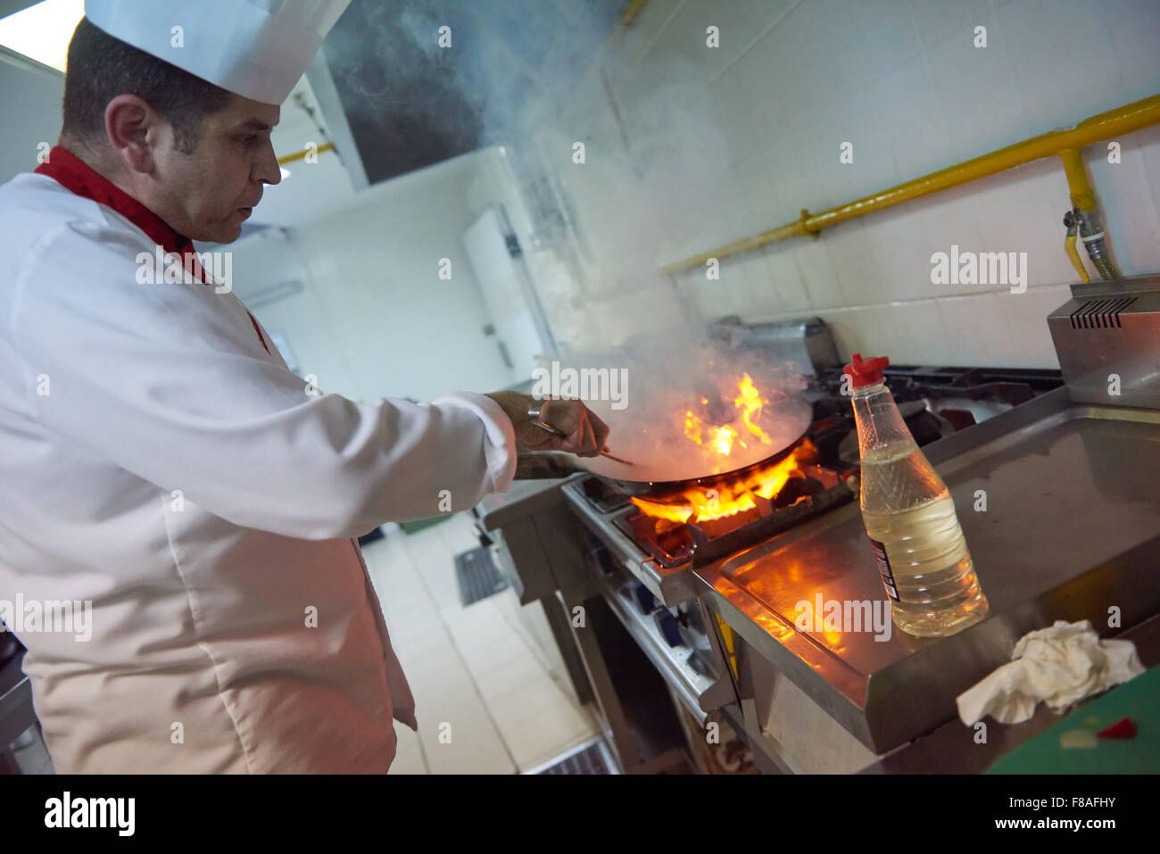 chef in hotel kitchen prepare vegetable food with fire Stock Photo - Alamy