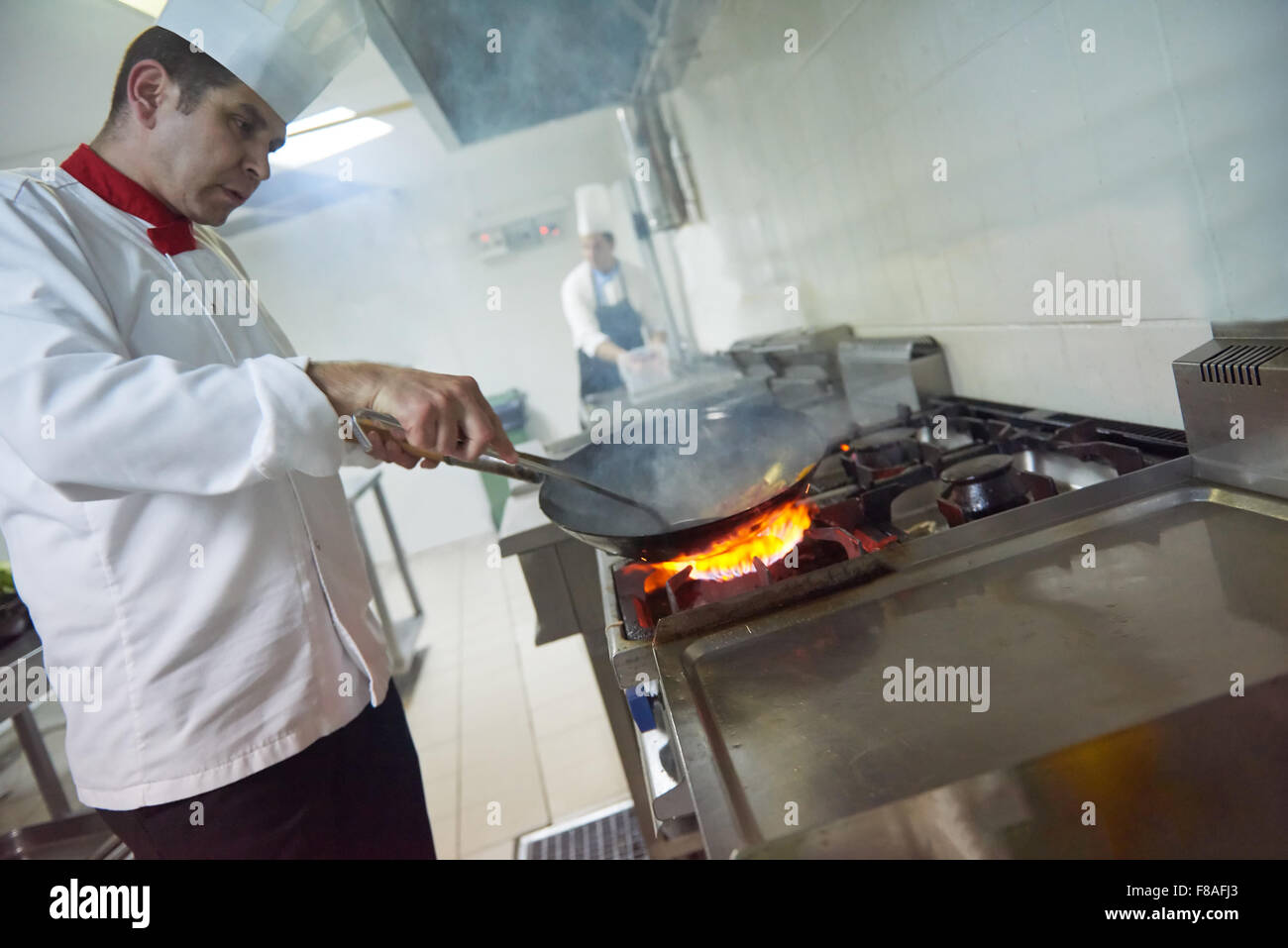 chef in hotel kitchen prepare vegetable food with fire Stock Photo - Alamy
