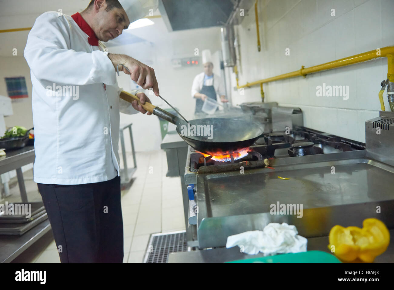 chef in hotel kitchen prepare vegetable food with fire Stock Photo - Alamy