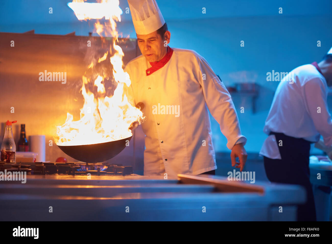 chef in hotel kitchen prepare vegetable food with fire Stock Photo - Alamy