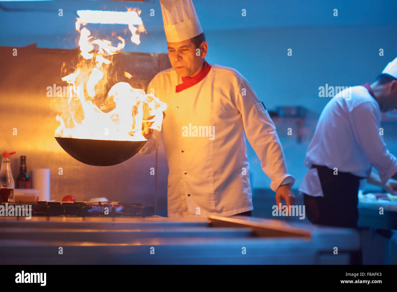 chef in hotel kitchen prepare vegetable food with fire Stock Photo - Alamy