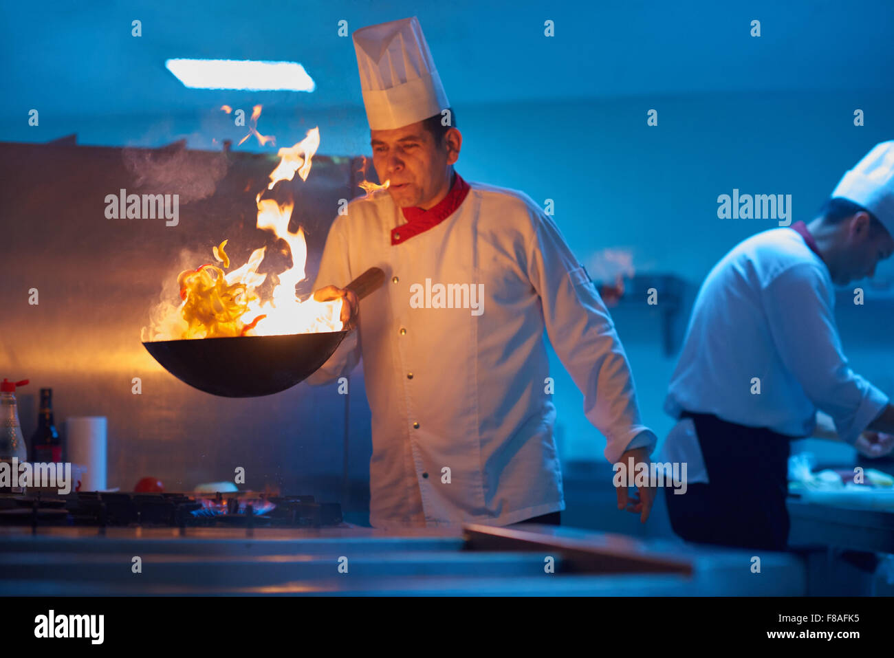 chef in hotel kitchen prepare vegetable food with fire Stock Photo - Alamy