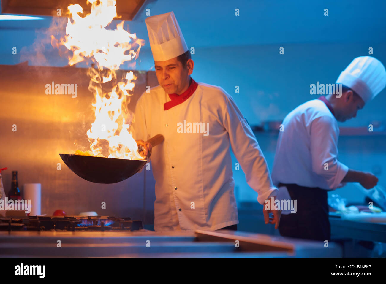 chef in hotel kitchen prepare vegetable food with fire Stock Photo - Alamy