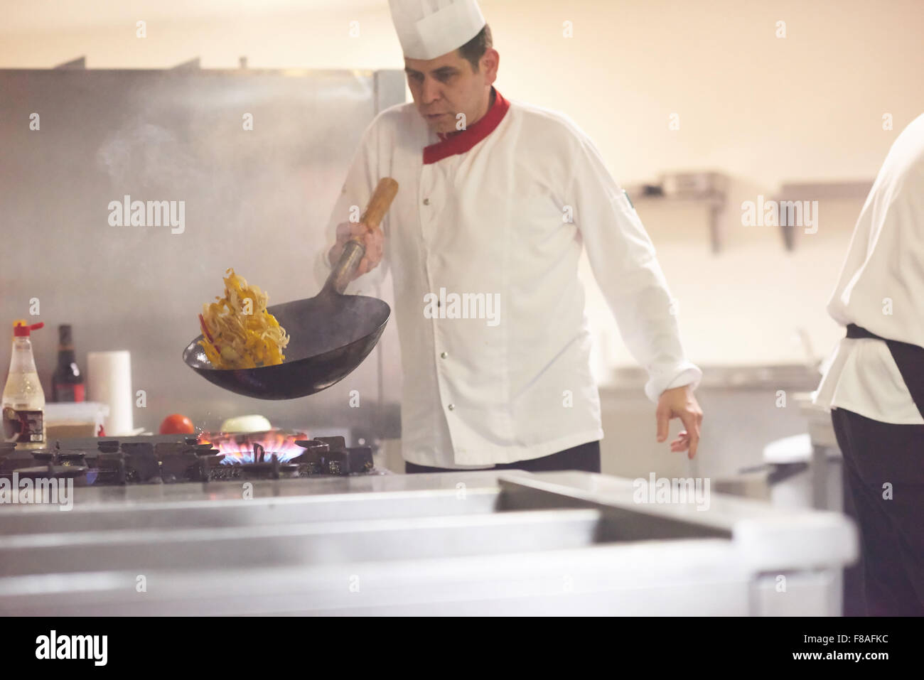 chef in hotel kitchen prepare vegetable food with fire Stock Photo - Alamy