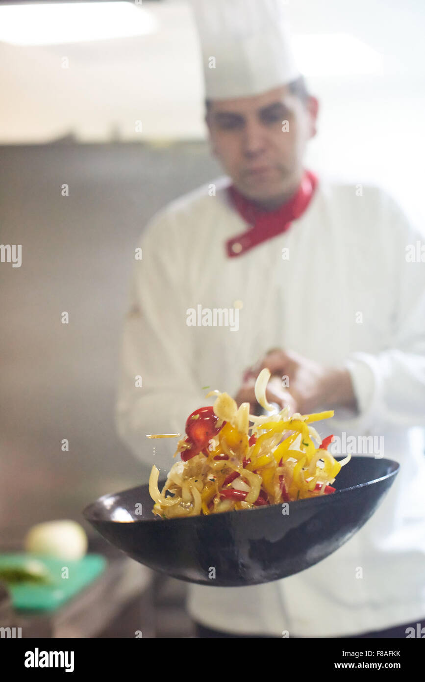 chef in hotel kitchen prepare vegetable food with fire Stock Photo - Alamy