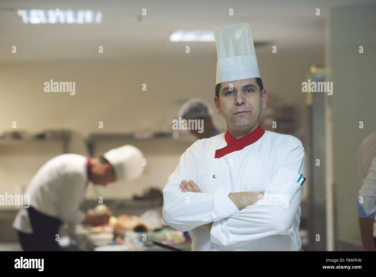 chef in hotel kitchen preparing and decorating food, delicious ...