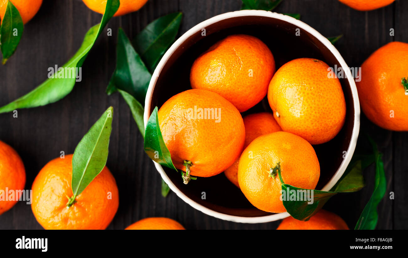 Tangerines on wooden background Stock Photo - Alamy