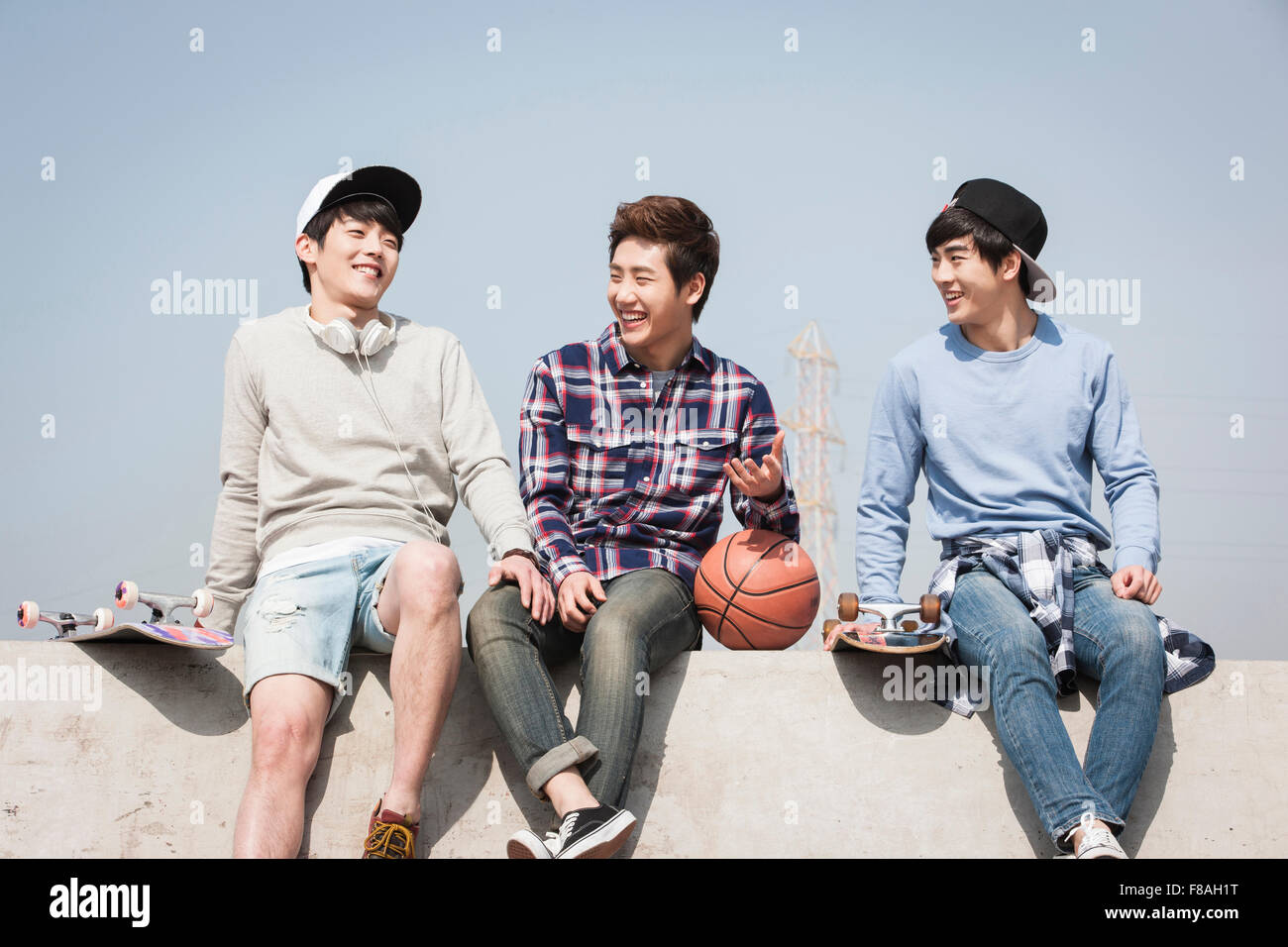 Three men standing and having fun together outside Stock Photo - Alamy
