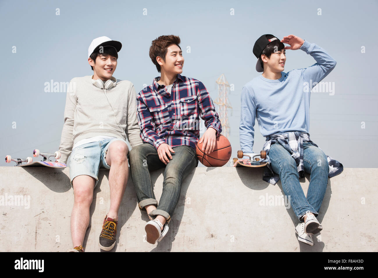 Three men sitting together and relaxing Stock Photo - Alamy