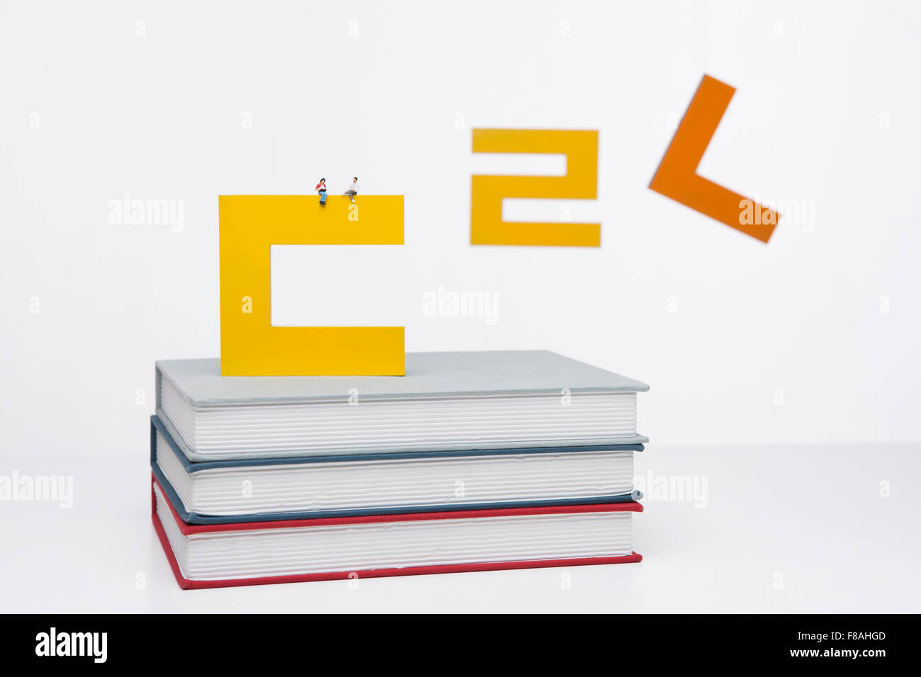 Human figures on a Korean character placed on the books out of focus ...